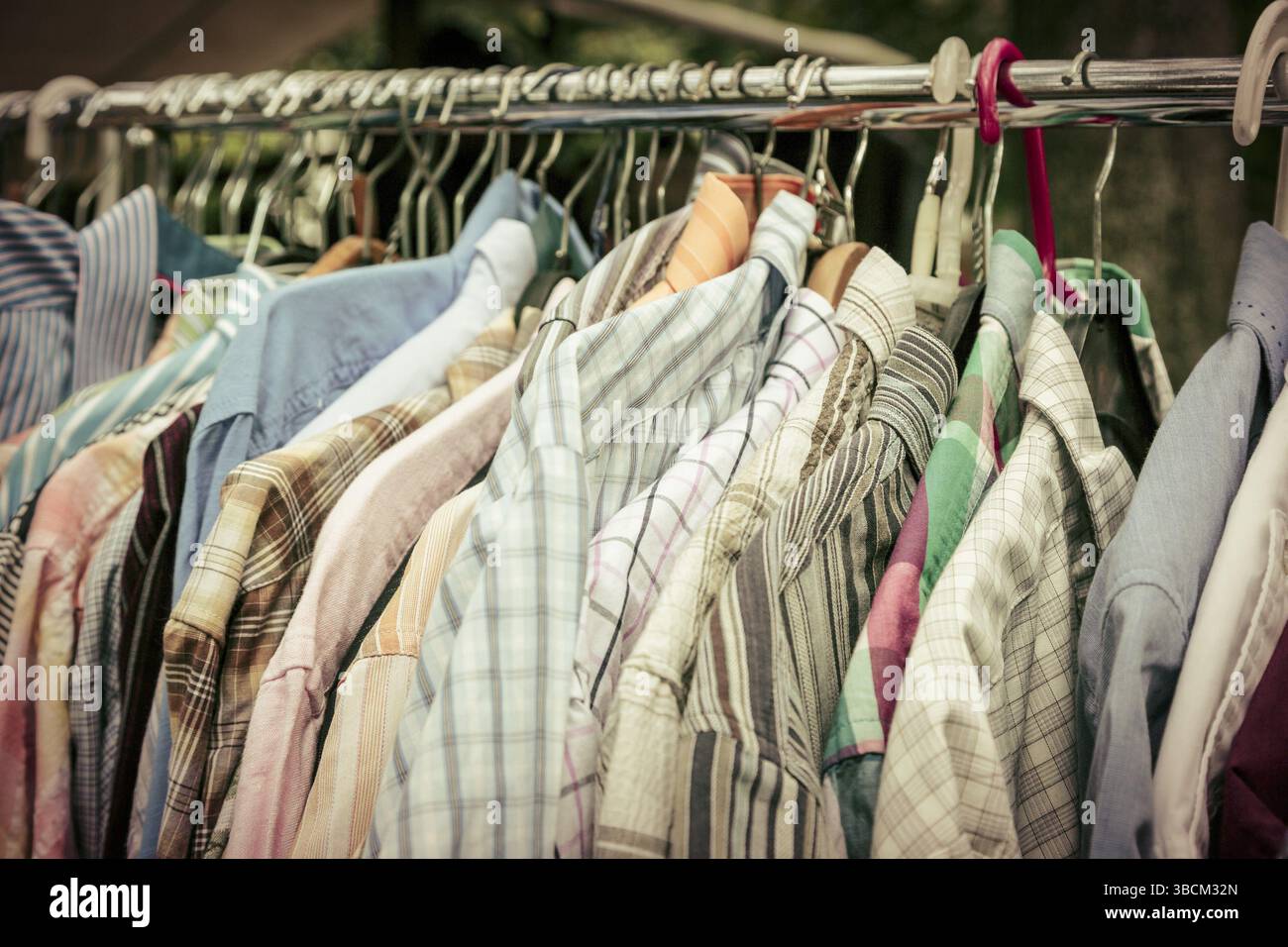 Clothes on a rack on a flea market Stock Photo - Alamy