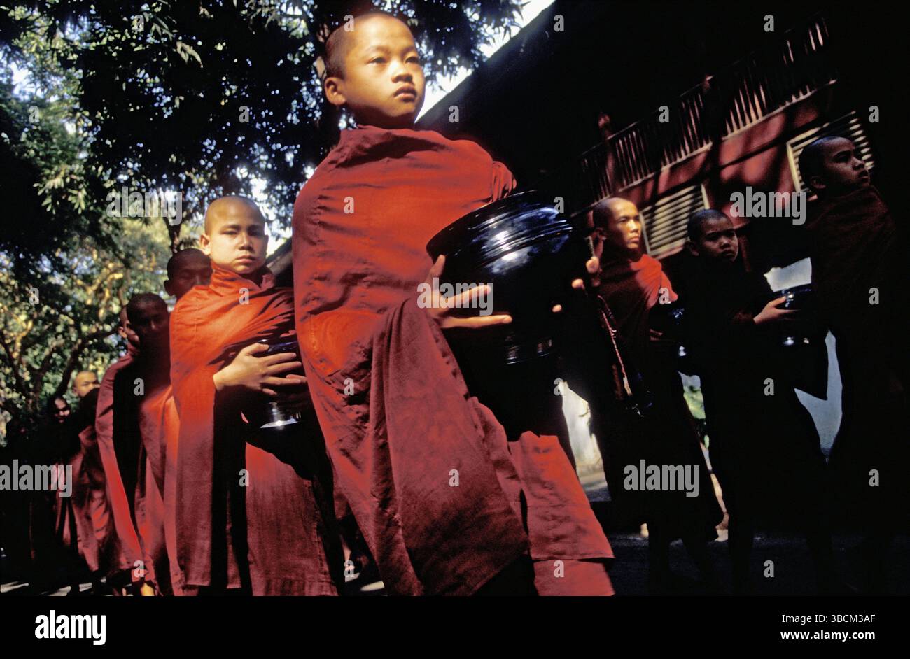 Buddhist monks carrying rice bowls, Amarapura, Mandalay, Burma Stock ...