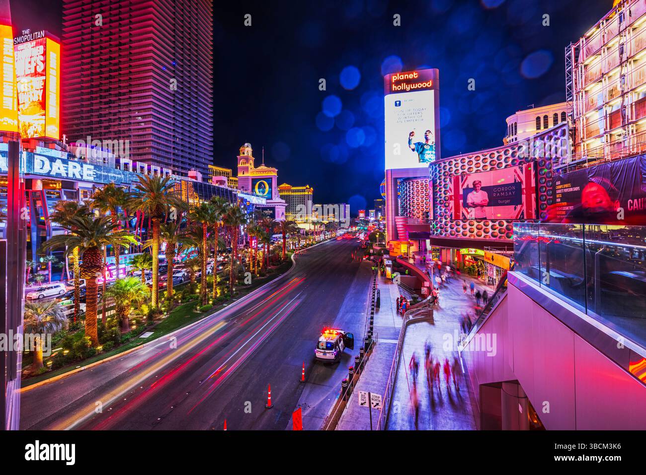 Blurred light trails and motion blur on Las Vegas Strip at night with neon lights and vibrant ...