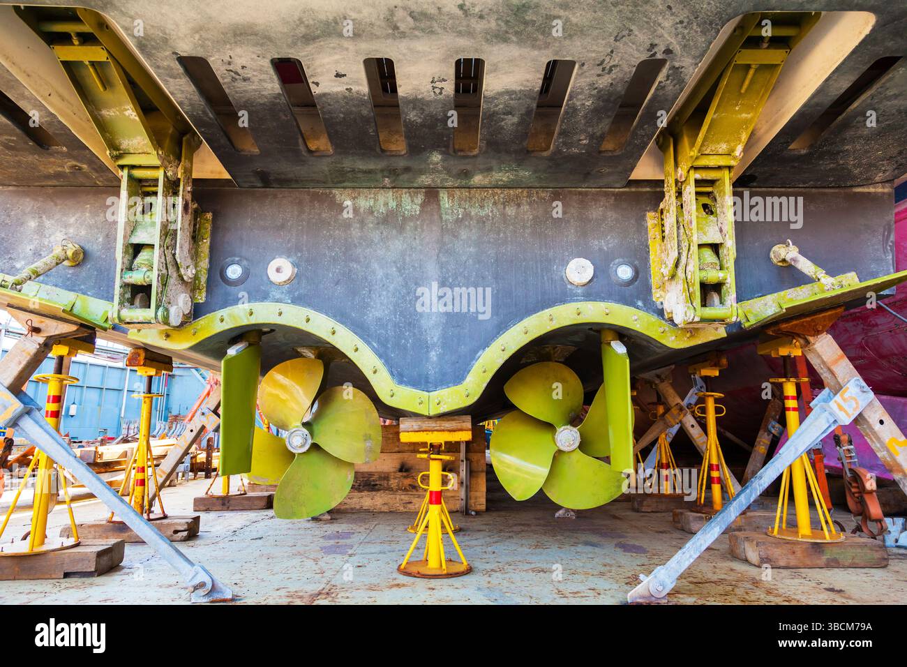 The back of a large motor yacht, standing on wooden blocks in a dry ...
