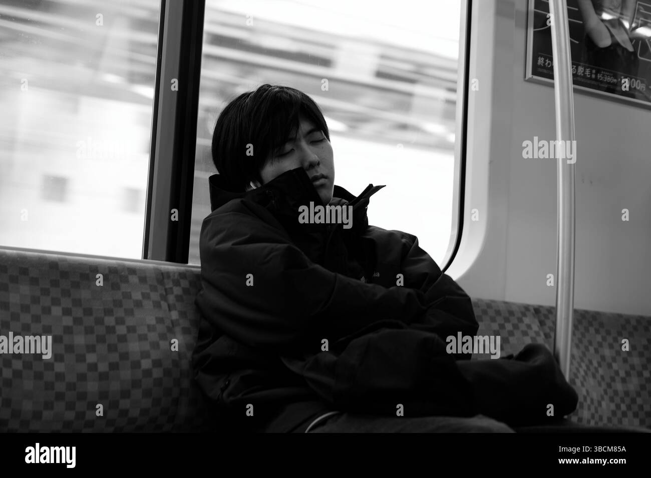 Monochrome commuter rests in solitude on the Tokyo metro Stock Photo ...