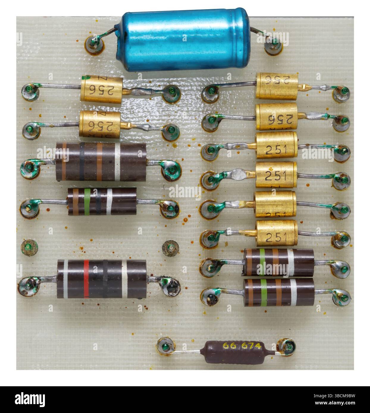 Overhead view of an aged electronic circuit board featuring resistors ...
