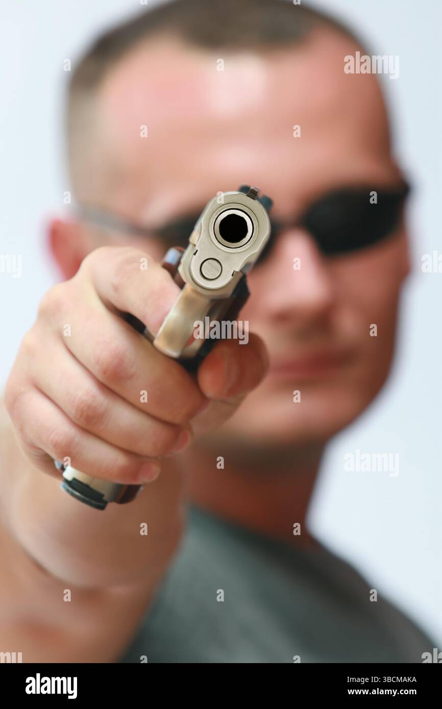 contractor private security guard aiming a pistol, front view down the ...
