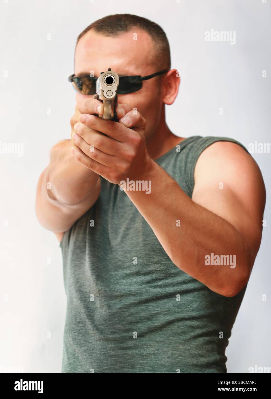 contractor private security guard aiming a pistol, front view down the ...