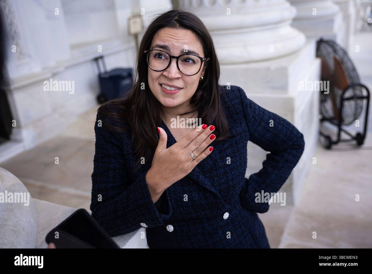 Rep. Alexandria Ocasio-Cortez (D-N.Y.) speaks with a reporter outside ...