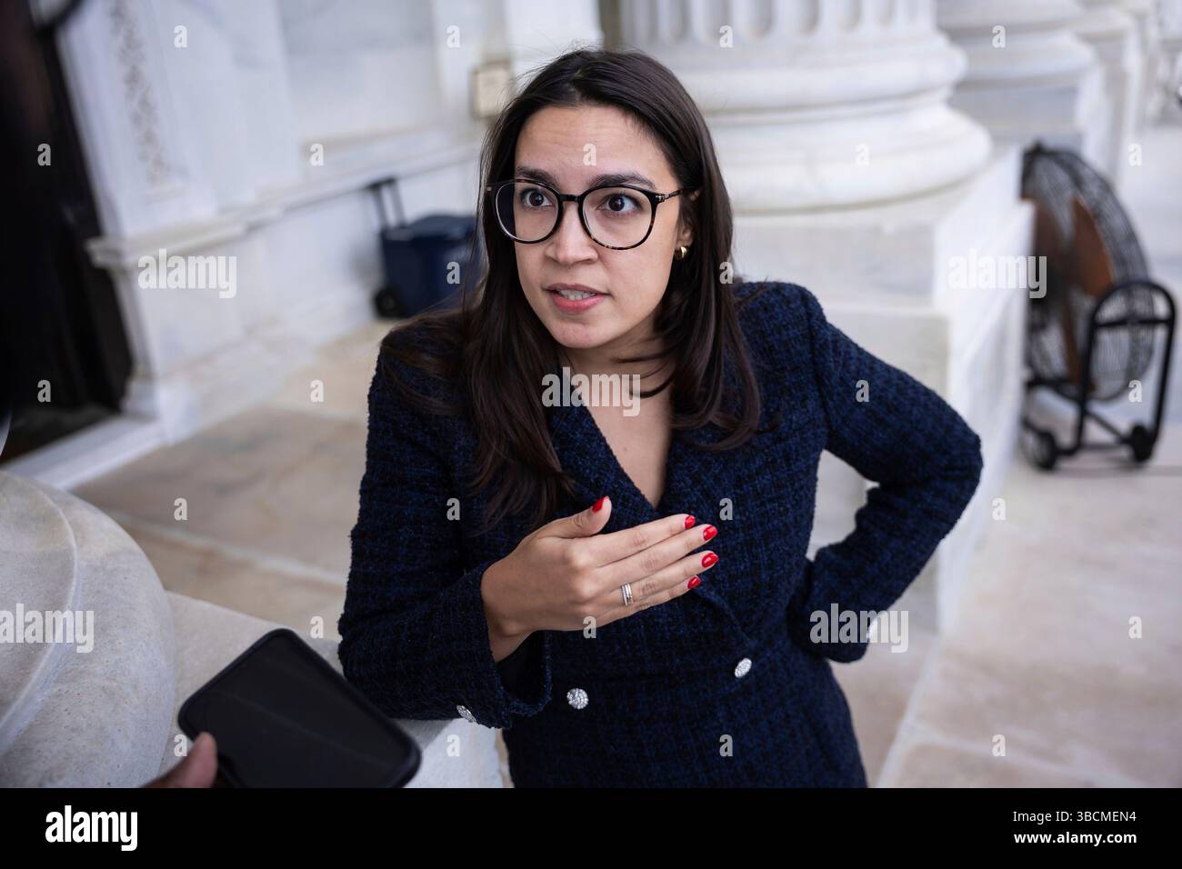 Rep. Alexandria Ocasio-Cortez (D-N.Y.) speaks with a reporter outside ...
