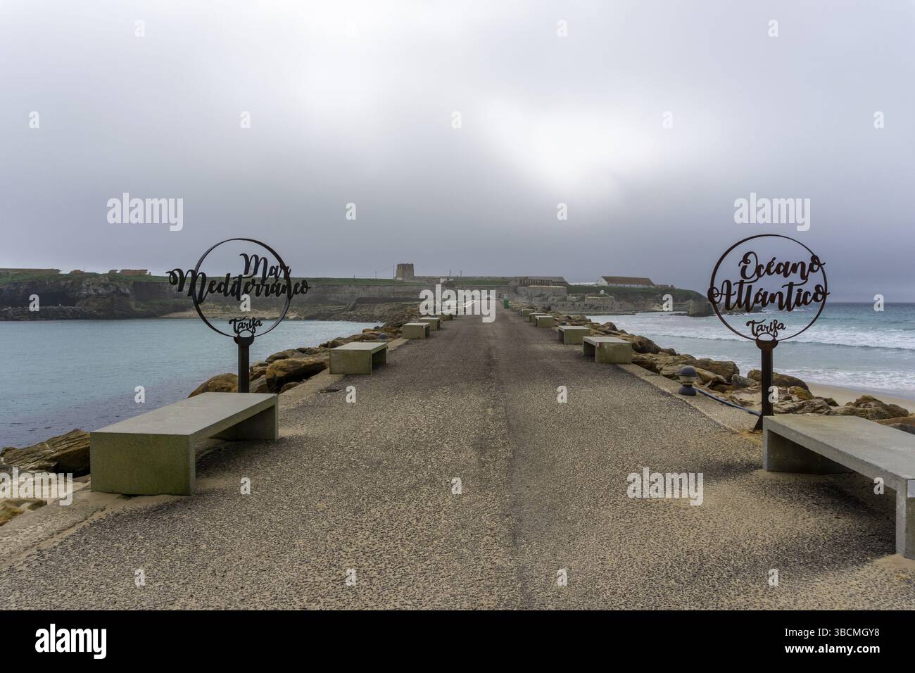 A signs on Palomas Island in Tarifa with the Mediterranenan Sea behind ...