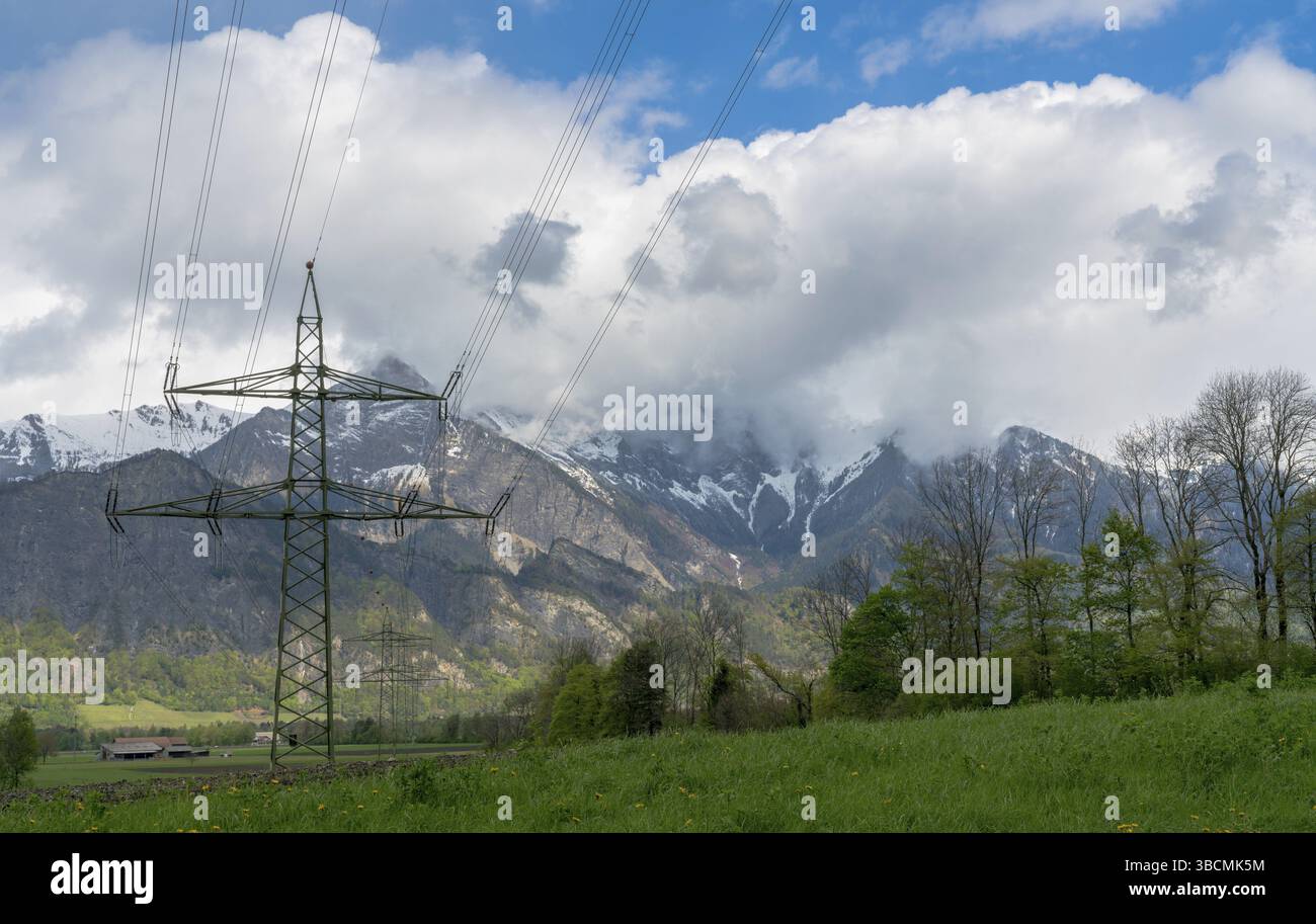 high voltage power line and lattice cross in agricultural farm fields ...