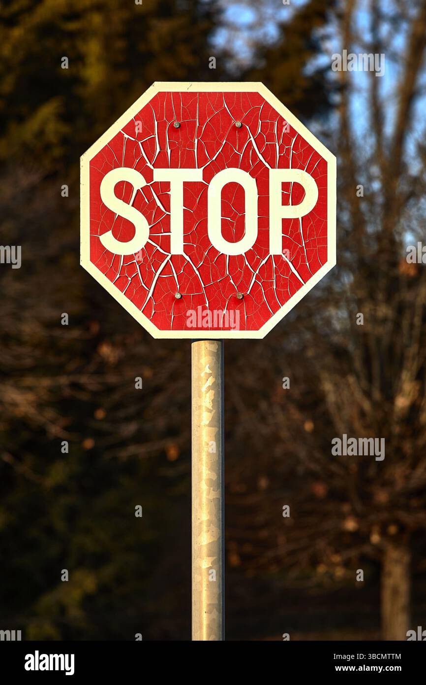 Stop sign with broken paint peeling Stock Photo - Alamy