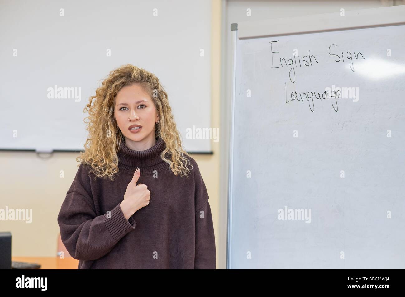 Caucasian female teacher communicates in Russian sign language with ...