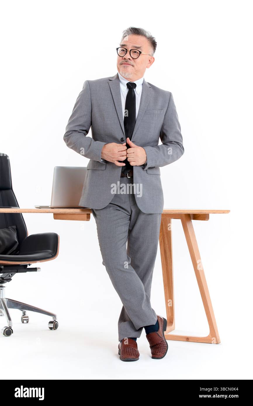 older business professional standing upright at a desk Stock Photo - Alamy