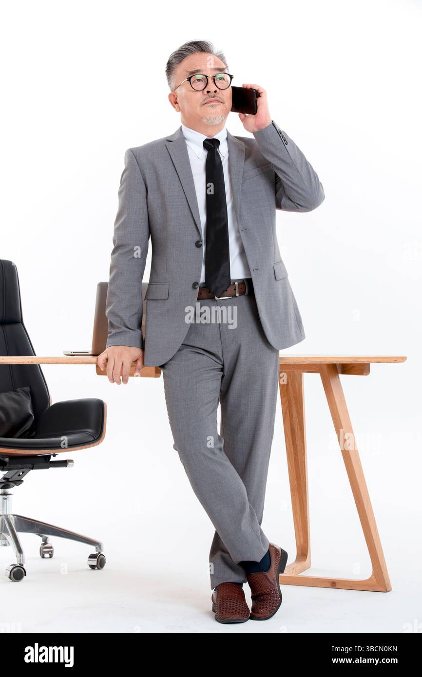 older business professional standing upright at a desk Stock Photo - Alamy