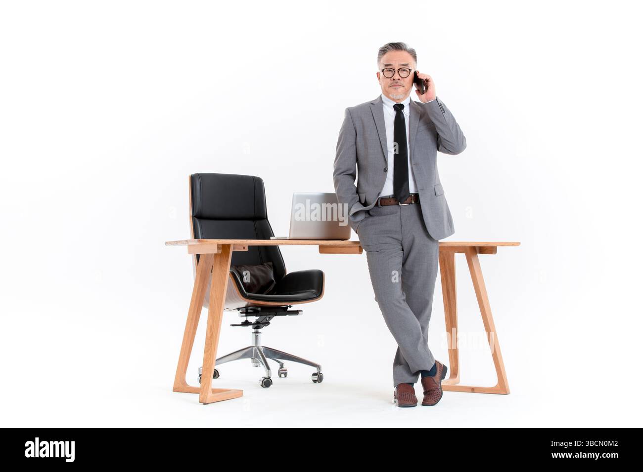 older business professional standing upright at a desk Stock Photo - Alamy