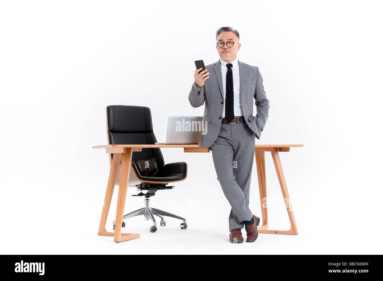 older business professional standing upright at a desk Stock Photo - Alamy