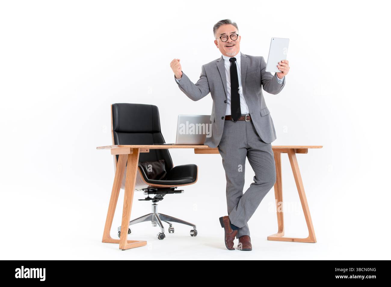 older business professional standing upright at a desk Stock Photo - Alamy