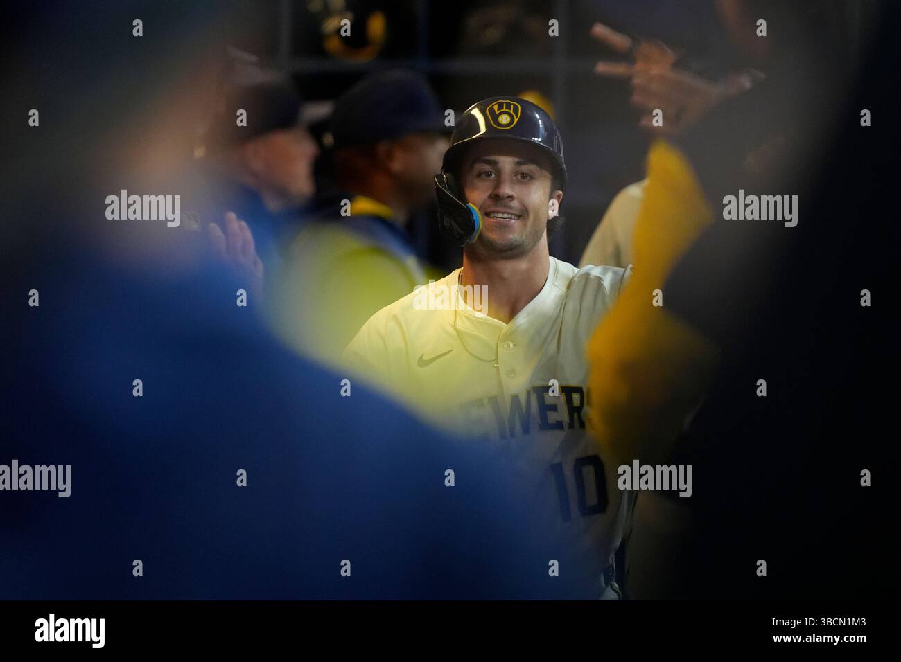 Milwaukee Brewers' Sal Frelick is congratulated in the dugout after ...