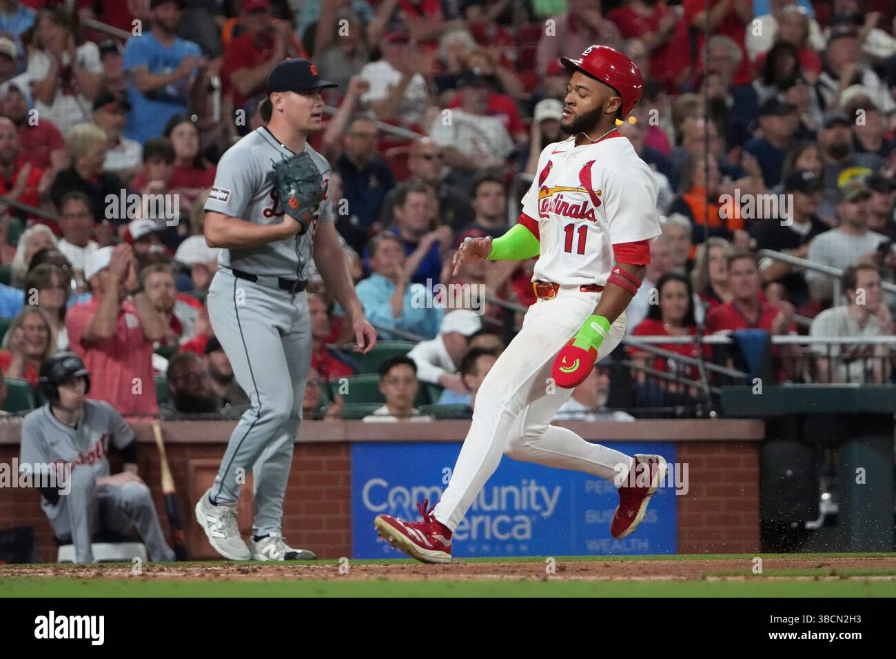 St. Louis Cardinals' Victor Scott II (11) scores past Detroit Tigers ...
