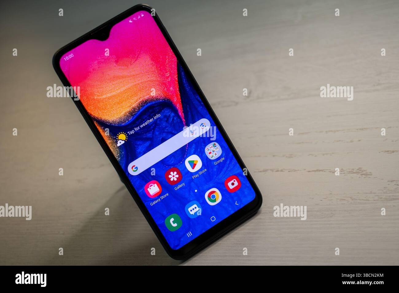 San Francisco, CA, May 20, 2025: Smartphone with multiple app icons on white table reflects ...