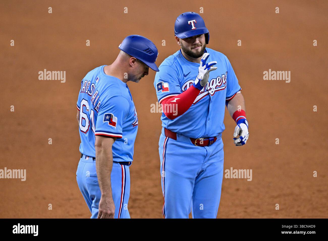 Texas Rangers' Jake Burger (right) points to the dugout as first base ...