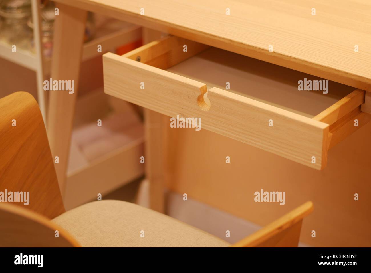 Desk with open drawer in a cozy workspace Stock Photo - Alamy