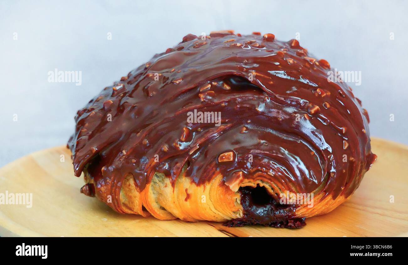 Close up Chocolate coated croissant with fudge chunks, Fresh baked made ...