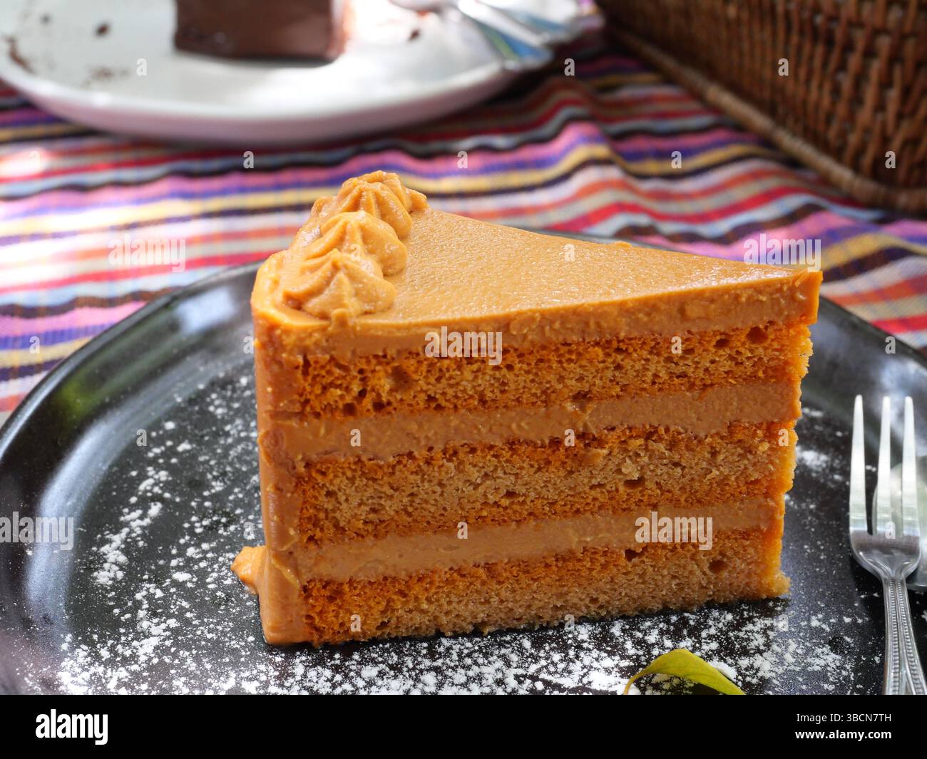 Triangle Thai Ceylon Tea cake in dish on table, Bakery covered with ...