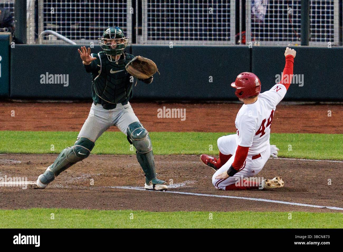 Michigan State's Noah Bright (18) motions as Nebraska's Gabe Swansen (44) scores a run during ...