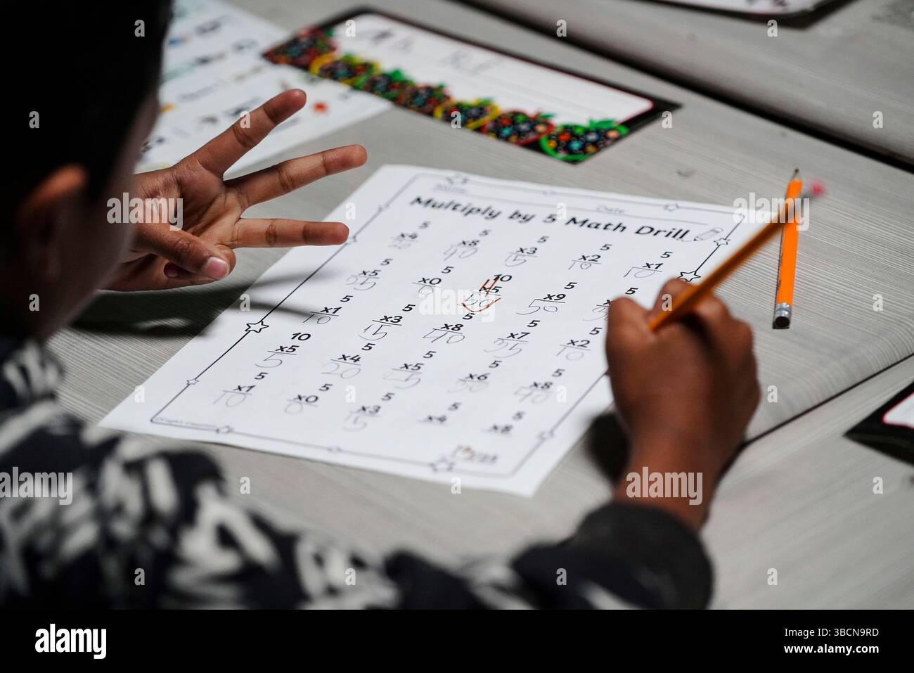 A second grader uses his hands to do math at Place Bridge Academy, May ...