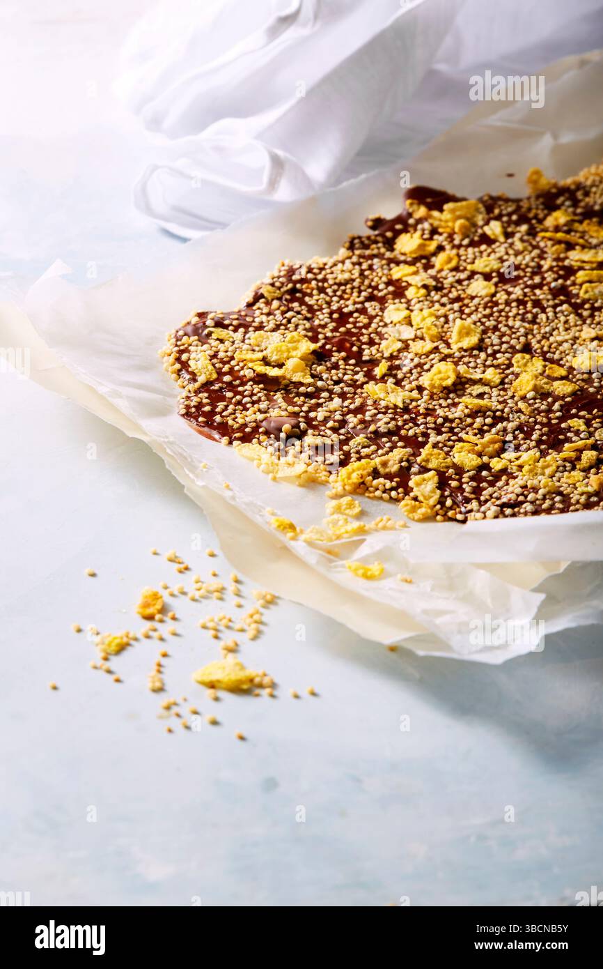 Chocolate bark with puffed quinoa and cornflakes on parchment Stock ...