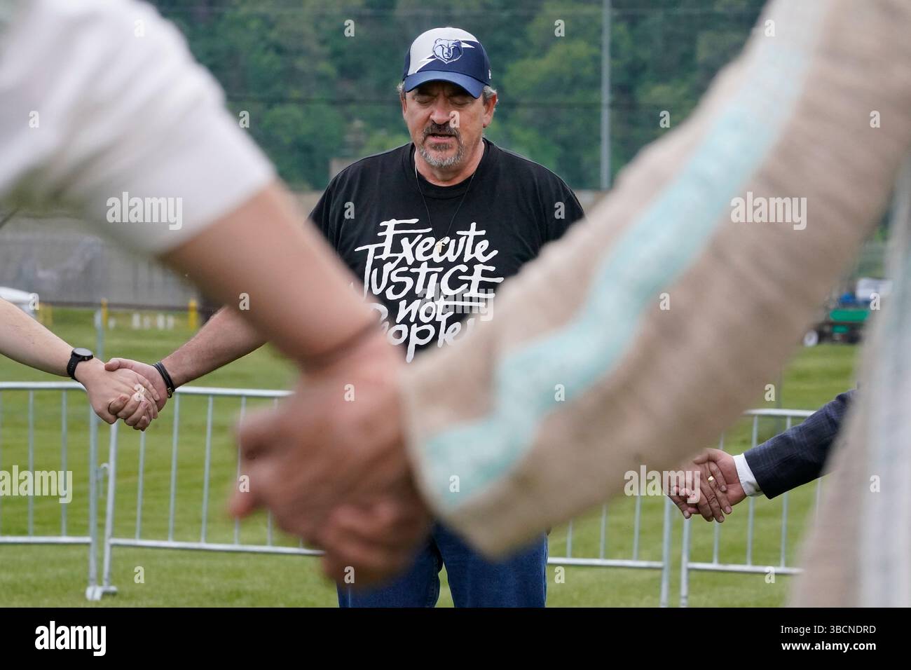 FILE - Dr. Kevin Riggs of Franklin Community Church prays with a group ...