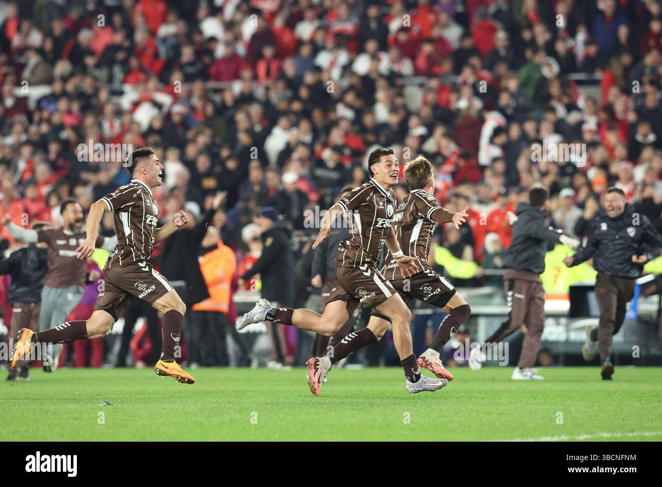 Platense's players celebrate after forward Ignacio Schor (out of frame ...