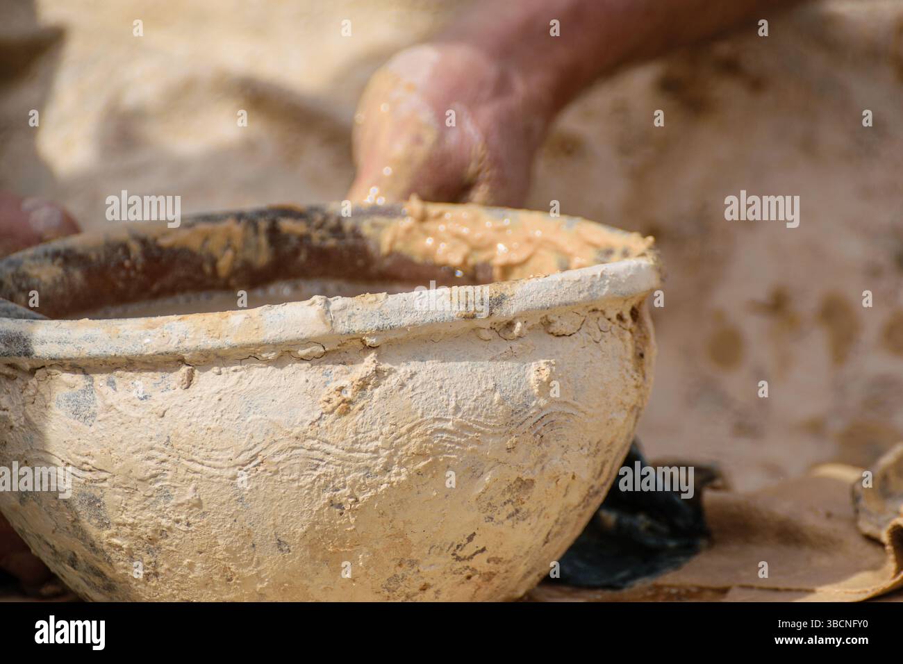 potter's hands preparing raw clay for creation artist preparing ...