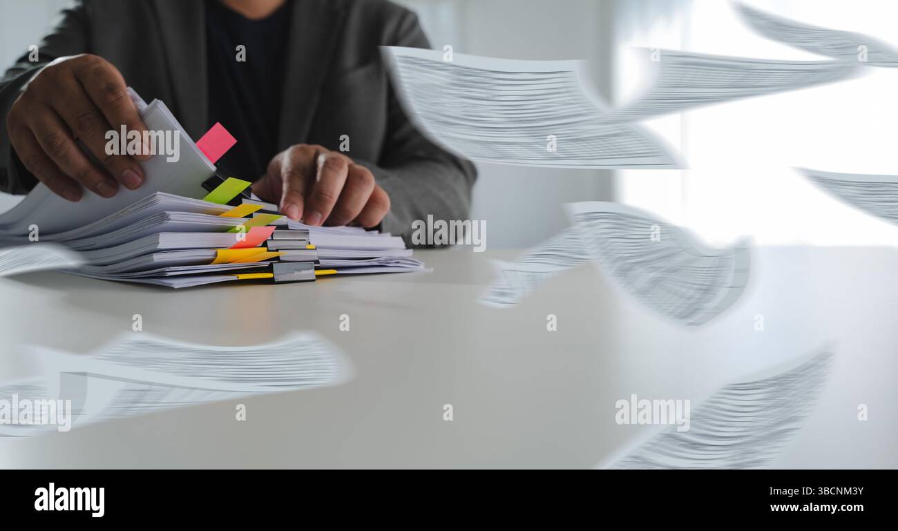 A many flying business documents person organizing and handling large ...