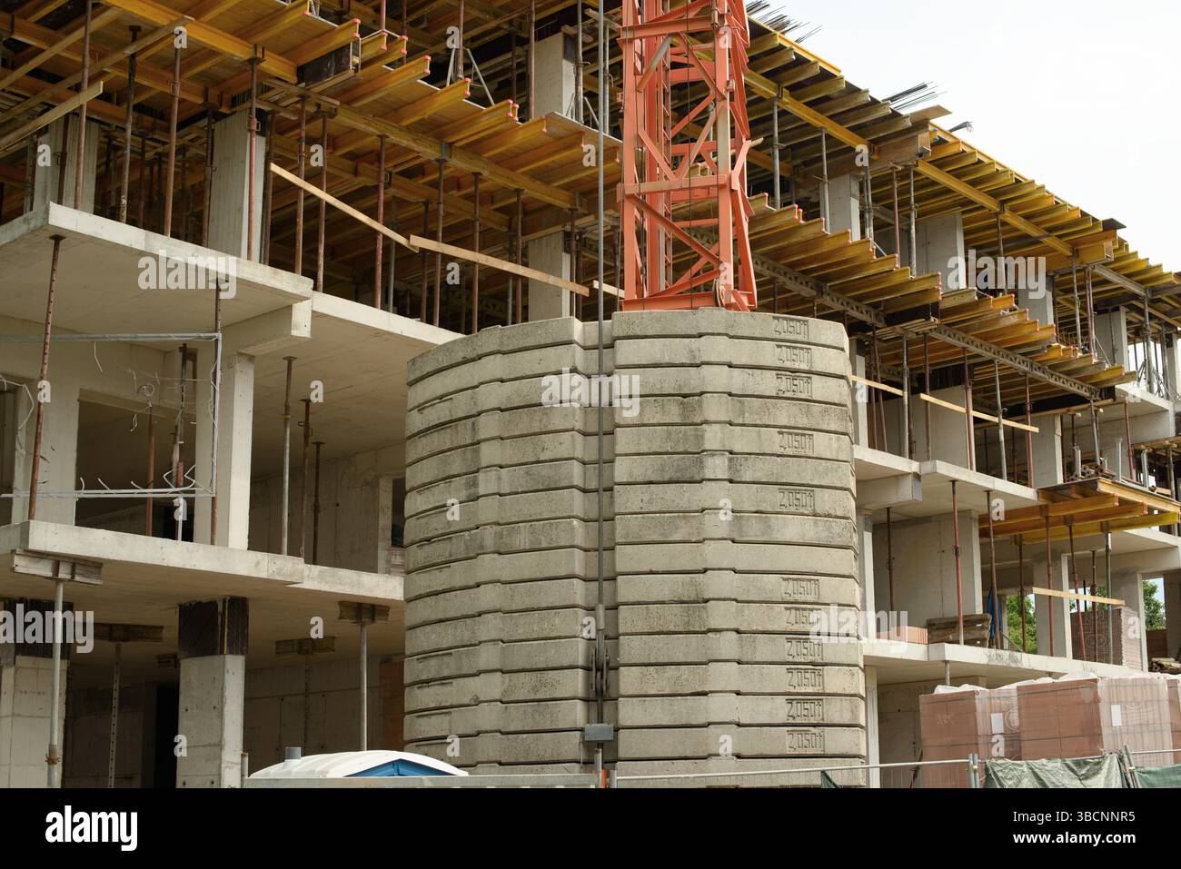 Multi story concrete building under construction featuring yellow ...