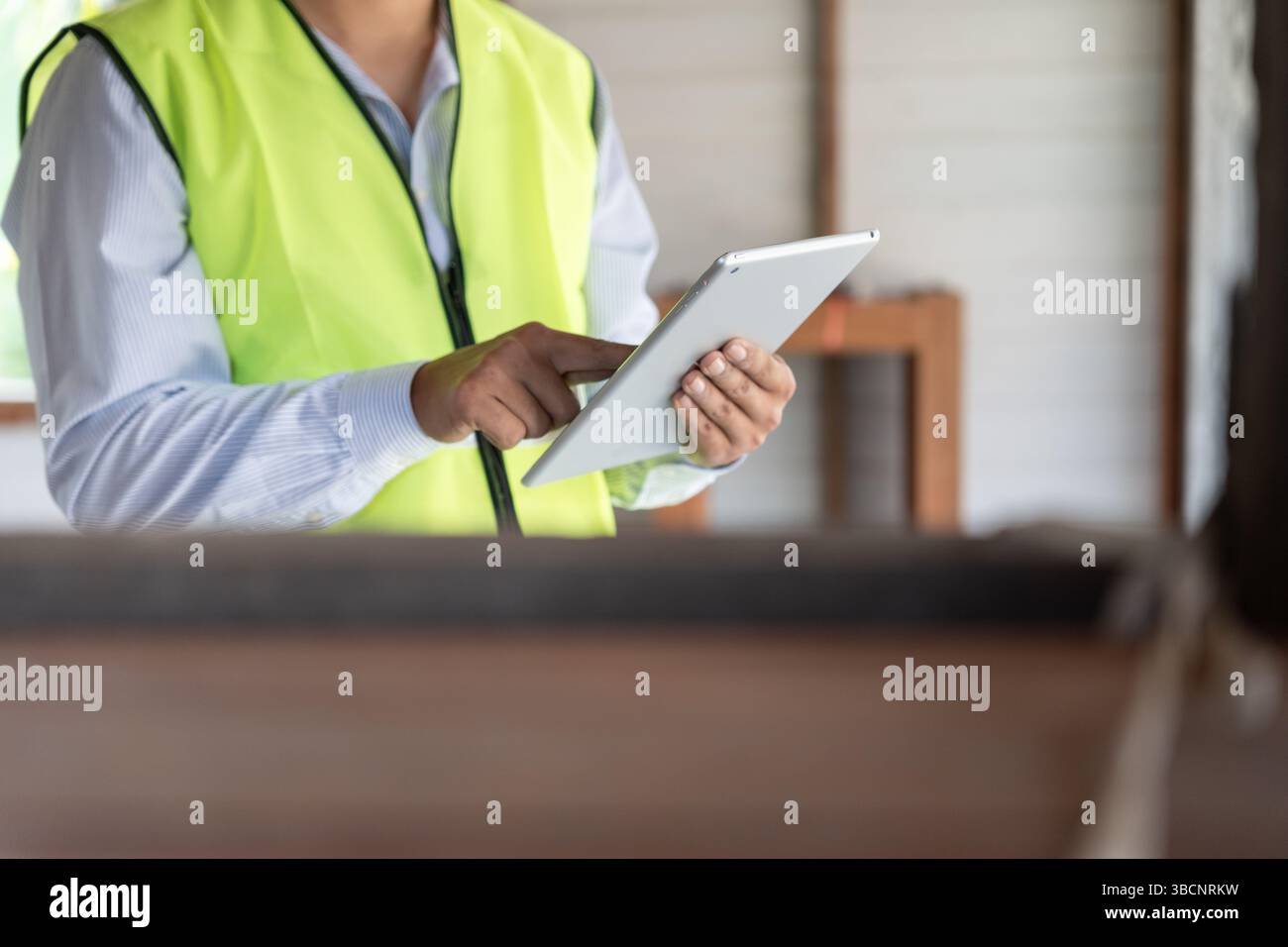 engineer is inspecting construction house using a tablet. Engineers and ...