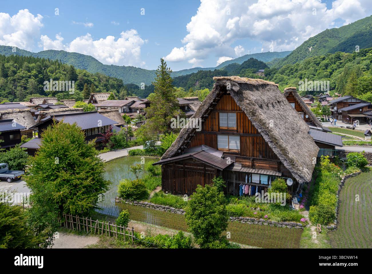 Thatched-roof houses and flooded rice paddies define the peaceful ...