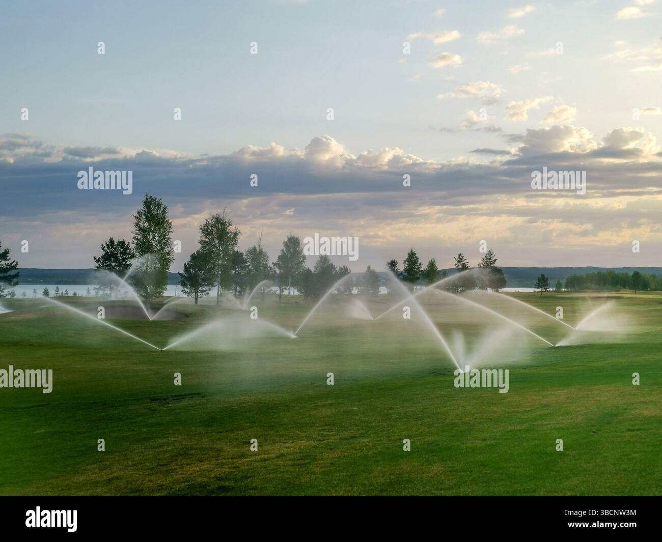 Irrigation sprinklers on golf course Stock Photo - Alamy