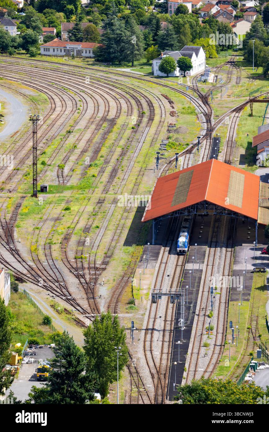Aerial view of a train leaving Capdenac station, surrounded by numerous ...