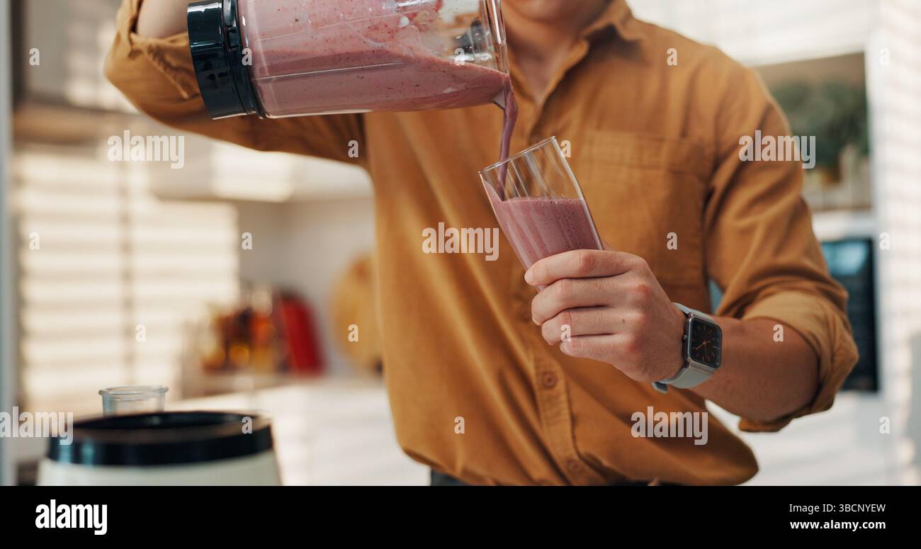 Hands, smoothie and man in kitchen, blender and nutrition with wellness ...