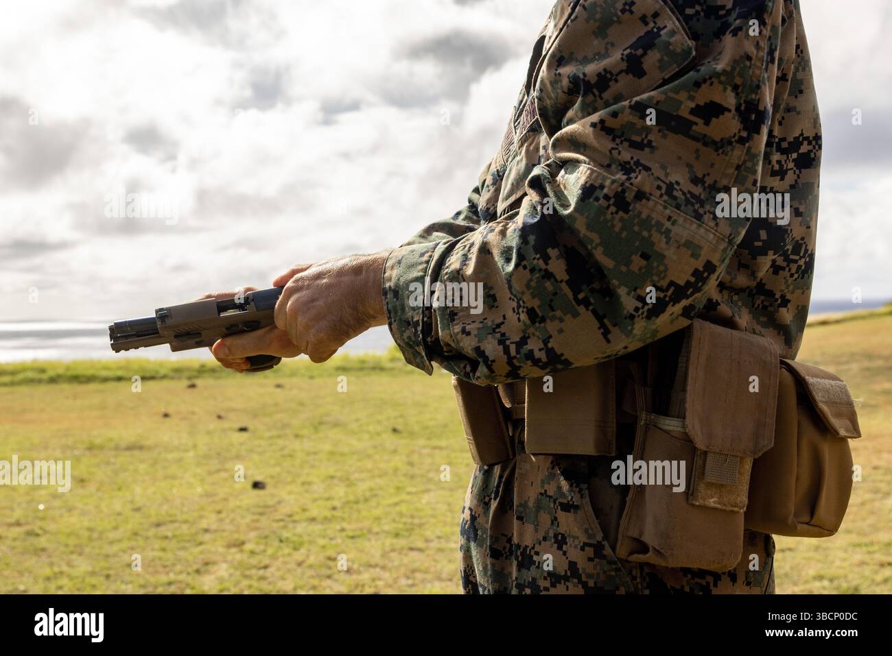 A U.S. Marine loads an M18 service pistol during an intramural shooting ...