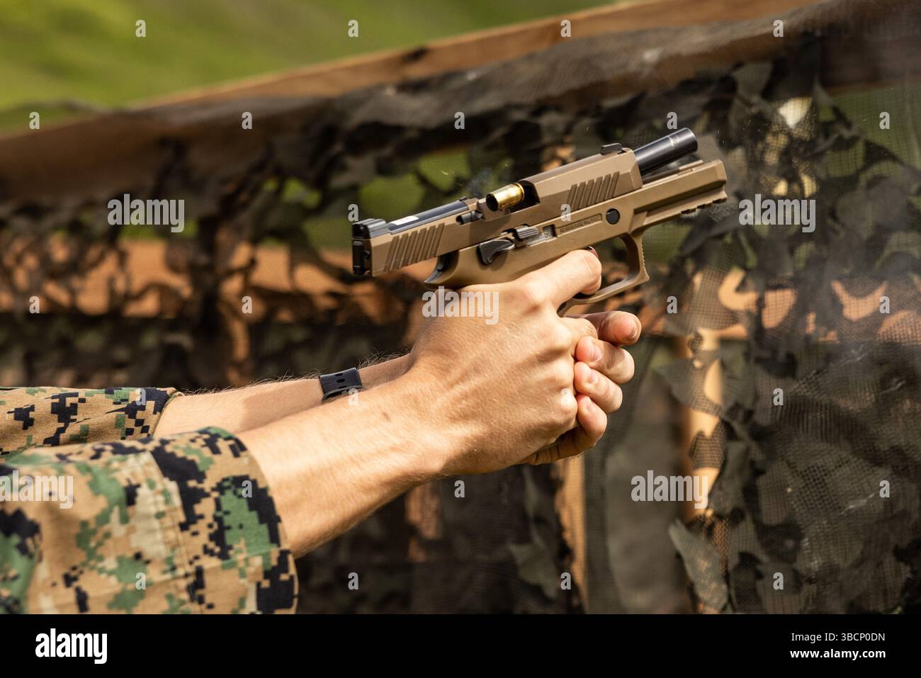 A U.S. Marine engages targets with an M18 service pistol during an ...