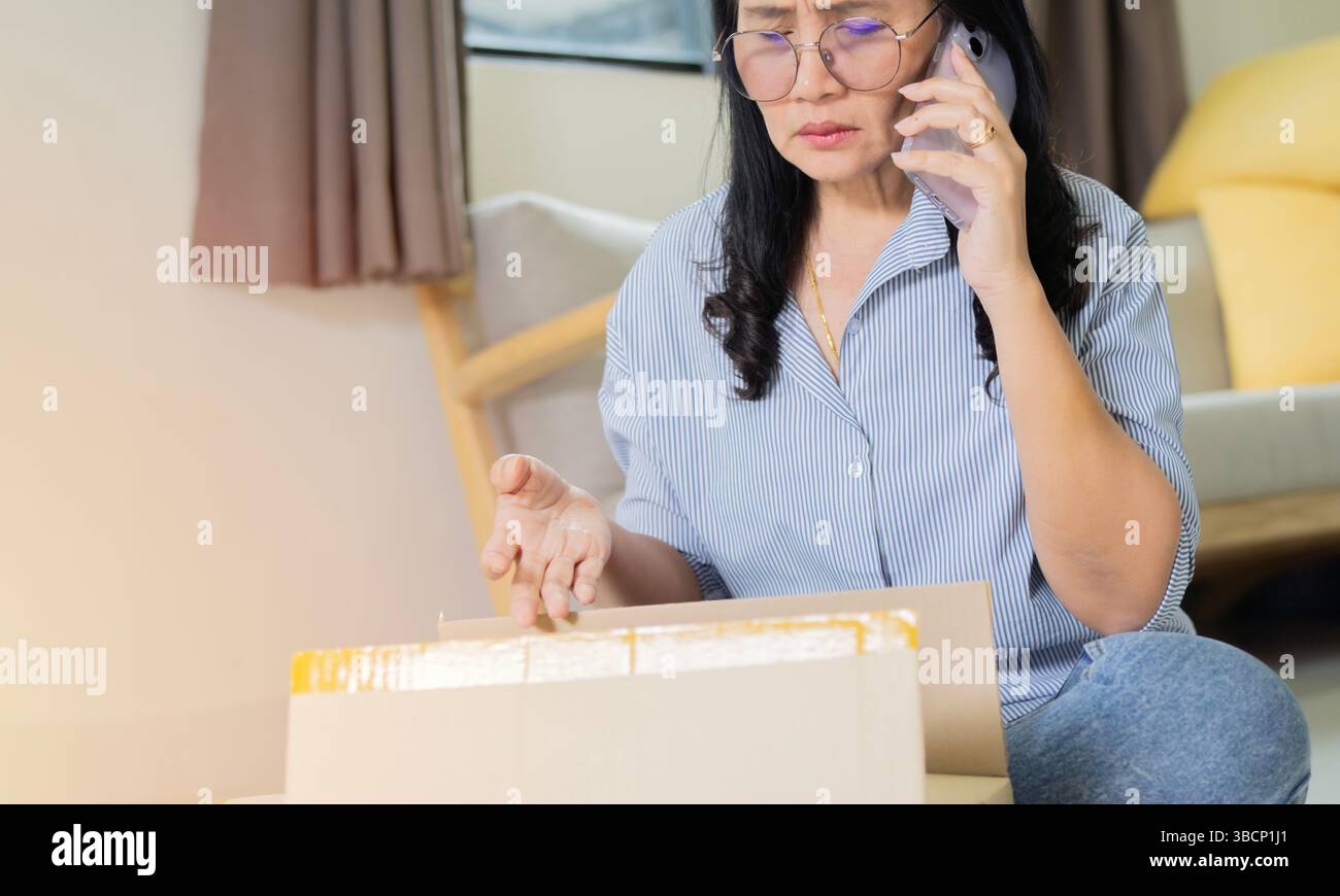 Asian woman using a phone with shocked expression while opening empty ...