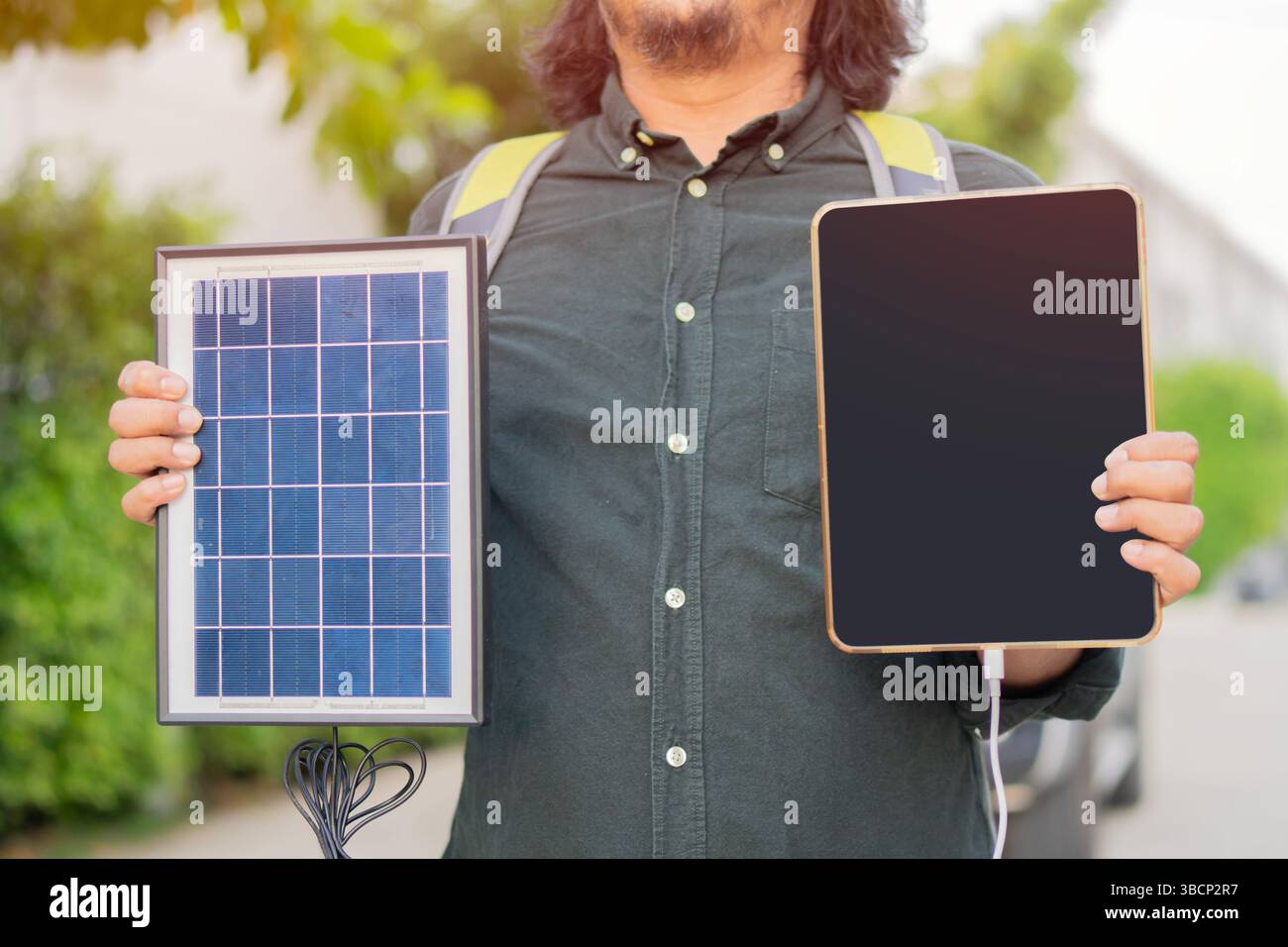 Close up view of man wear a backpack and hands charging his devices ...
