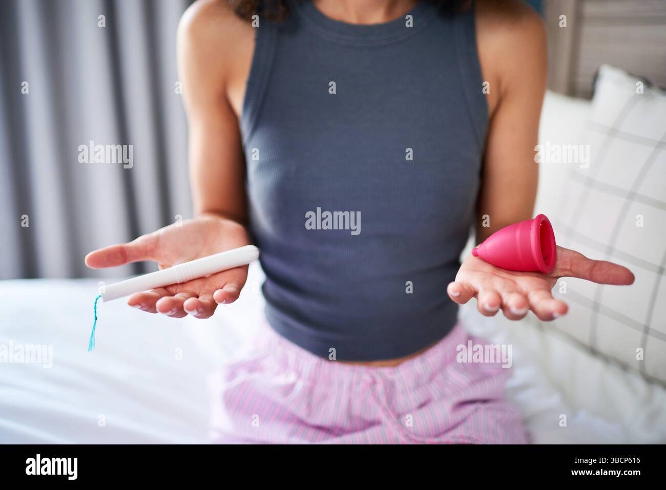 Woman comparing period products hi-res stock photography and images - Alamy