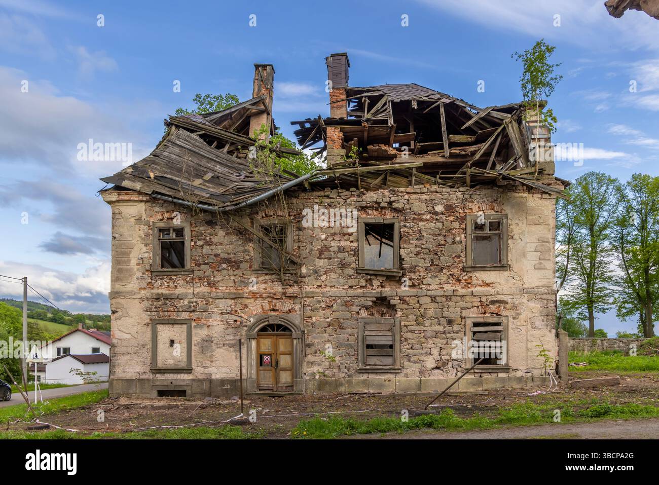 Old abandoned house with broken windows and collapsed roof is being ...