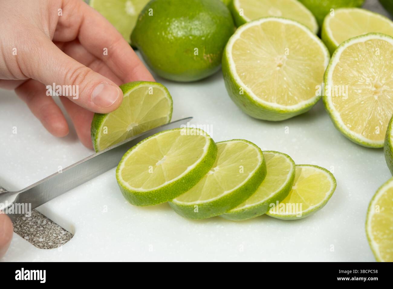 Process slicing fresh lime hi-res stock photography and images - Alamy