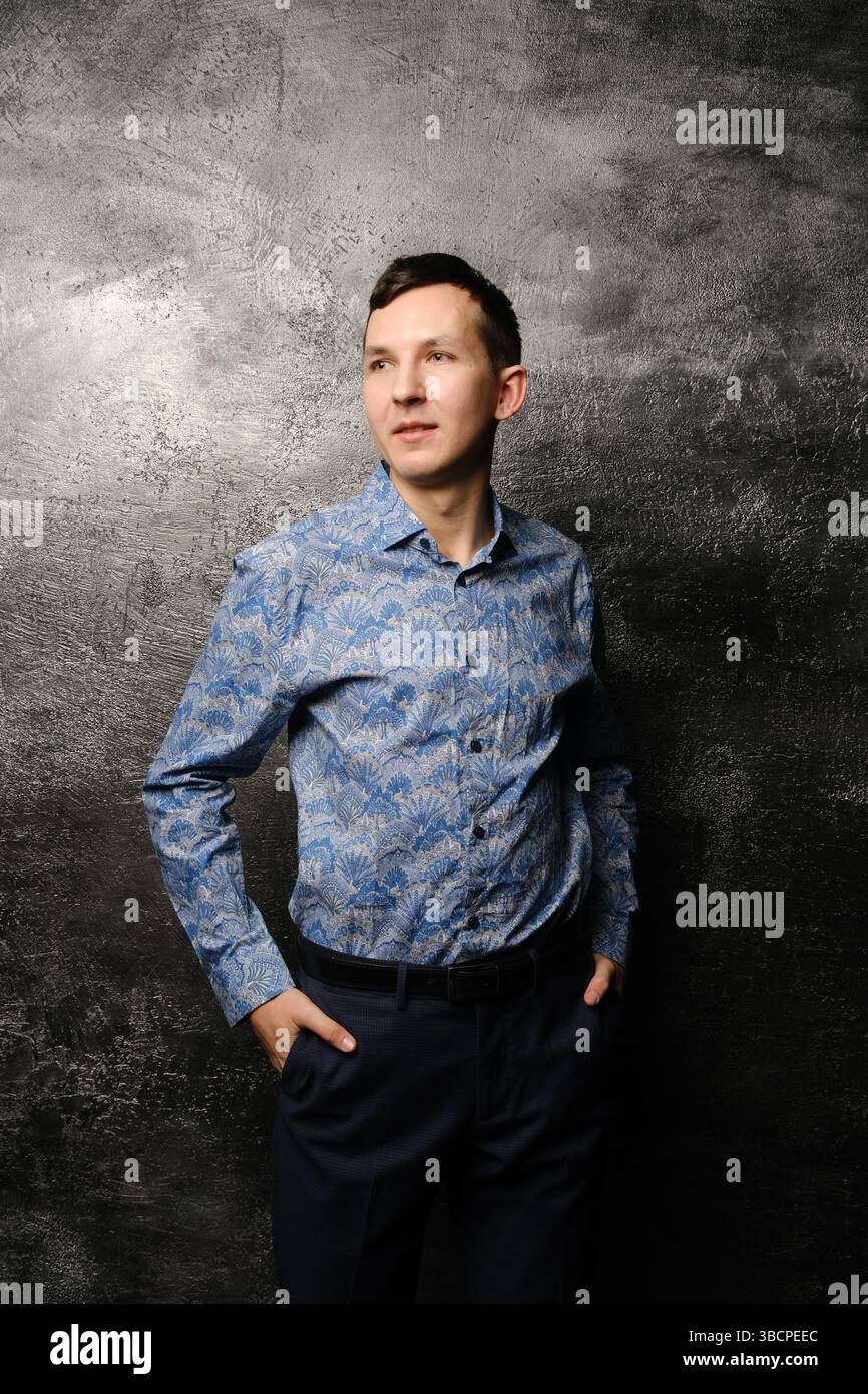 A Stylish Young Man Posing Confidently Against a Unique and Textured ...
