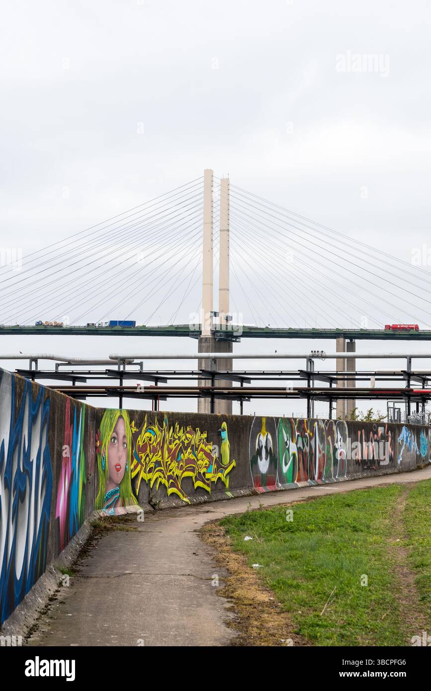 Graffiti along the Thames Path sea wall in the industrial area of West ...