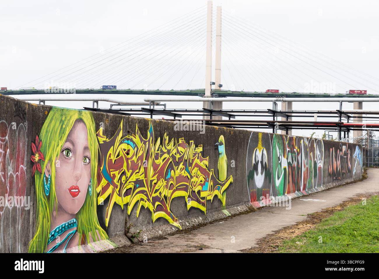 Graffiti along the Thames Path sea wall in the industrial area of West ...