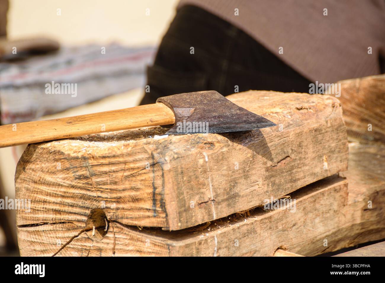 a small axe on the work table of a woodcarving craftsman, tradition ...